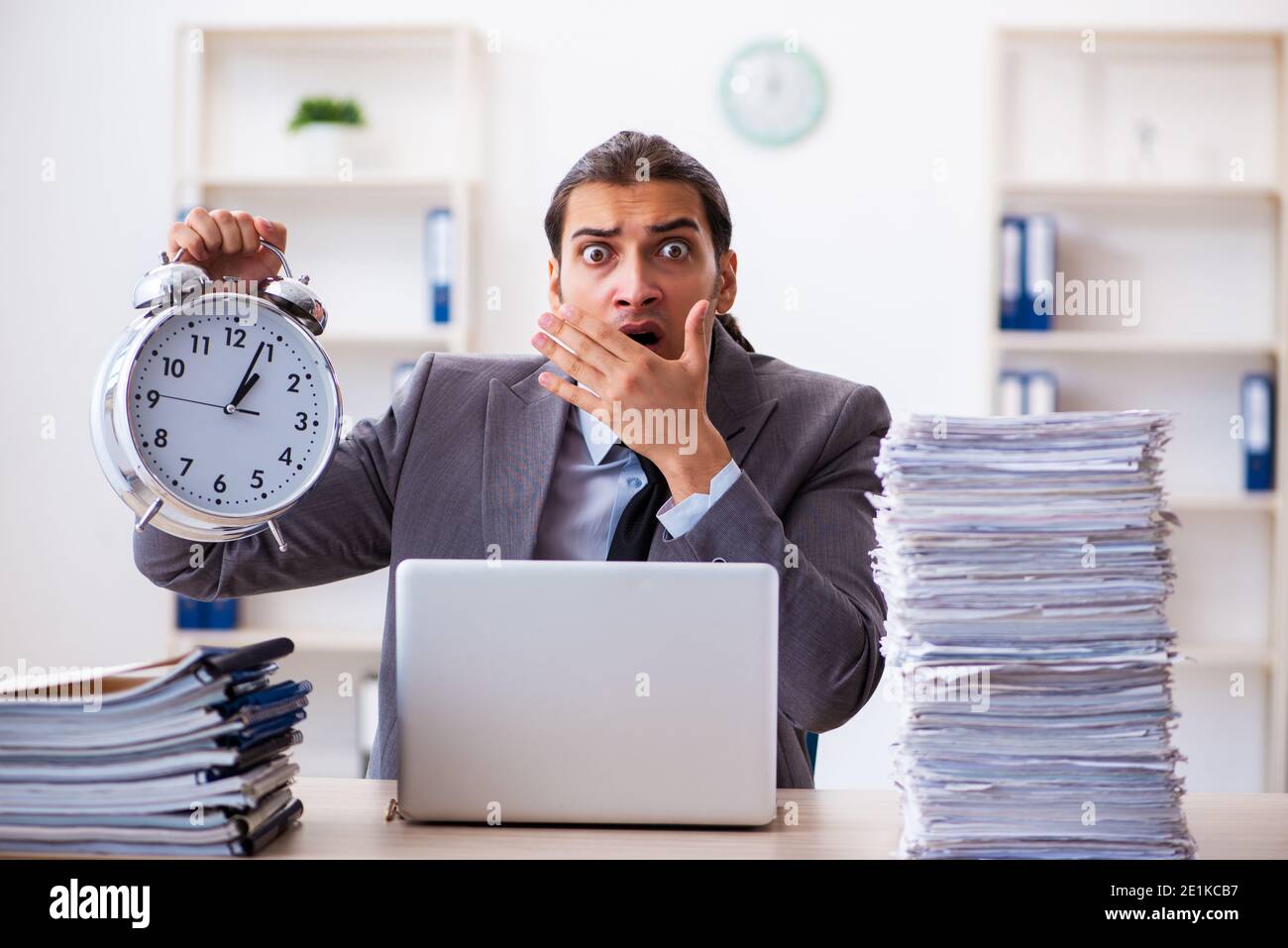 Workload employee in time management concept Stock Photo - Alamy