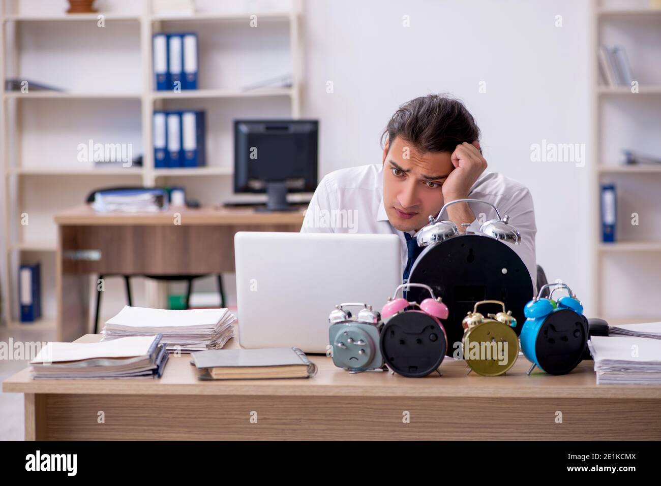 Young employee afraid of missing deadline at workplace Stock Photo - Alamy