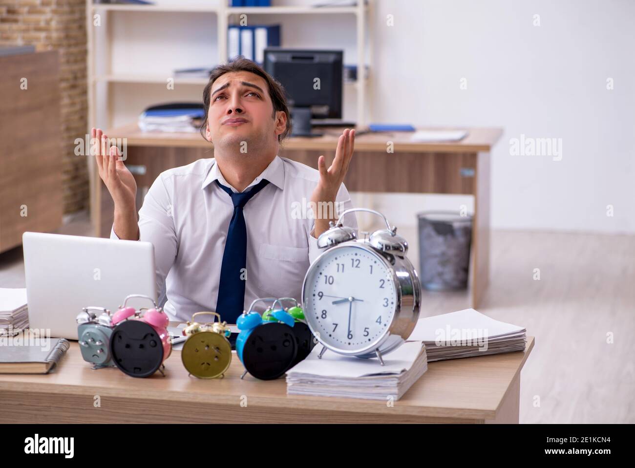 Young employee afraid of missing deadline at workplace Stock Photo - Alamy