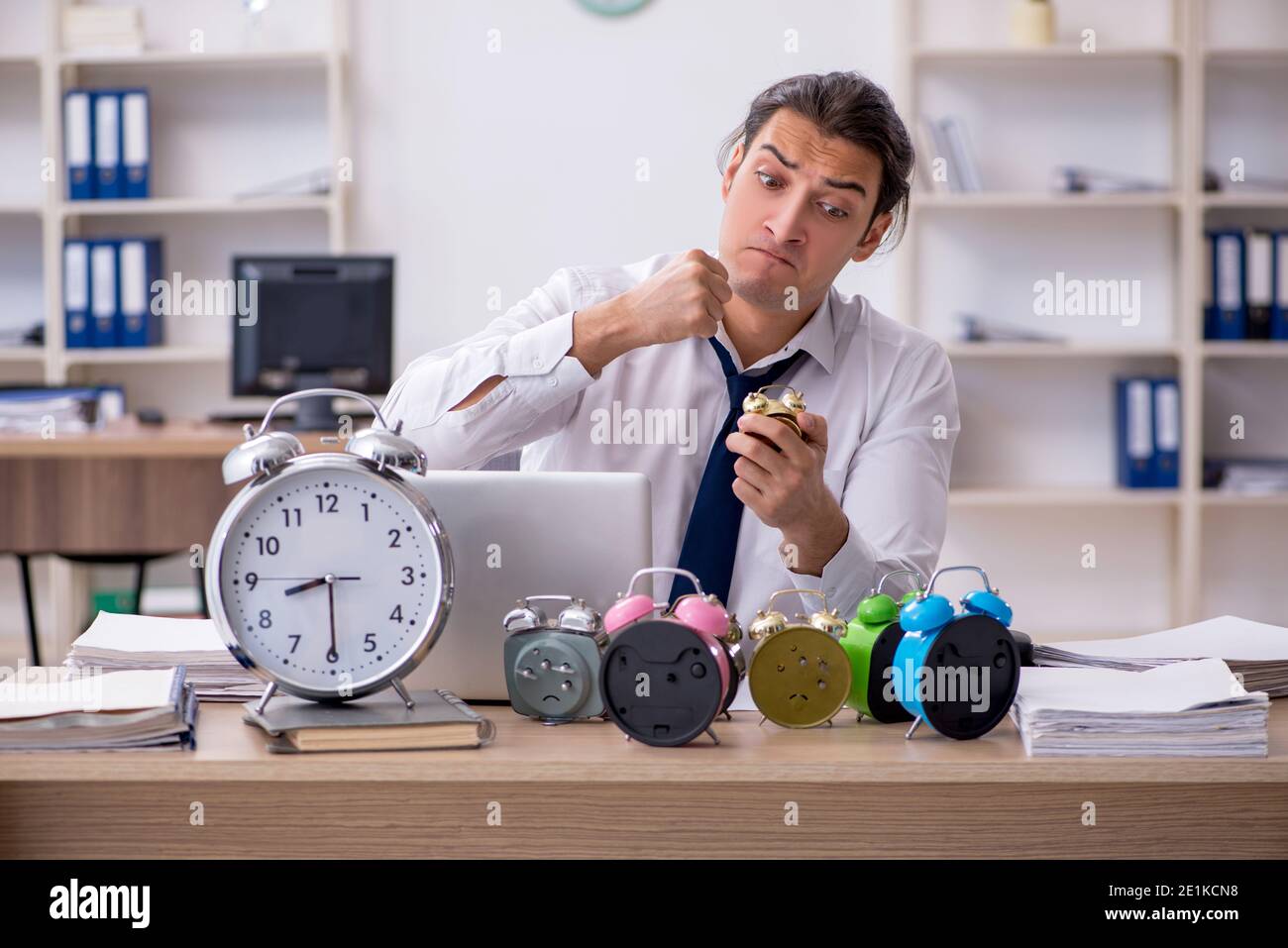 Young employee afraid of missing deadline at workplace Stock Photo - Alamy