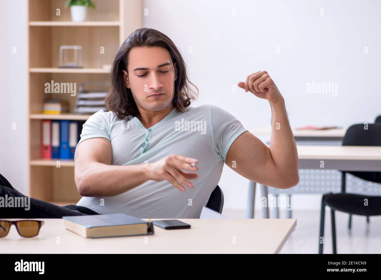 Male student smoking cigarettes in the classroom Stock Photo - Alamy