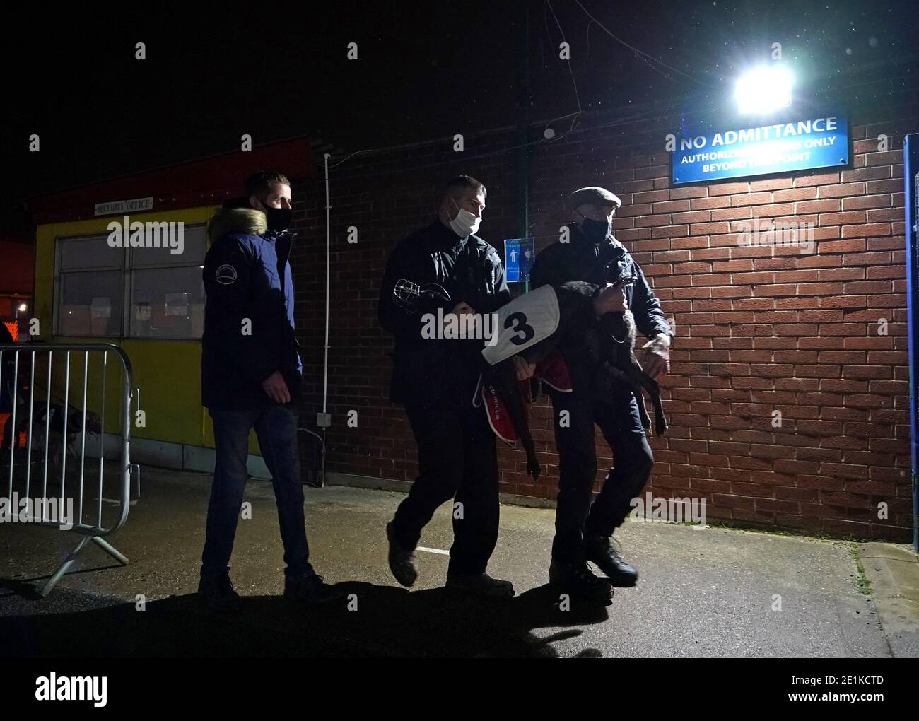 Going Through is carried back to the kennels after their race at Perry ...