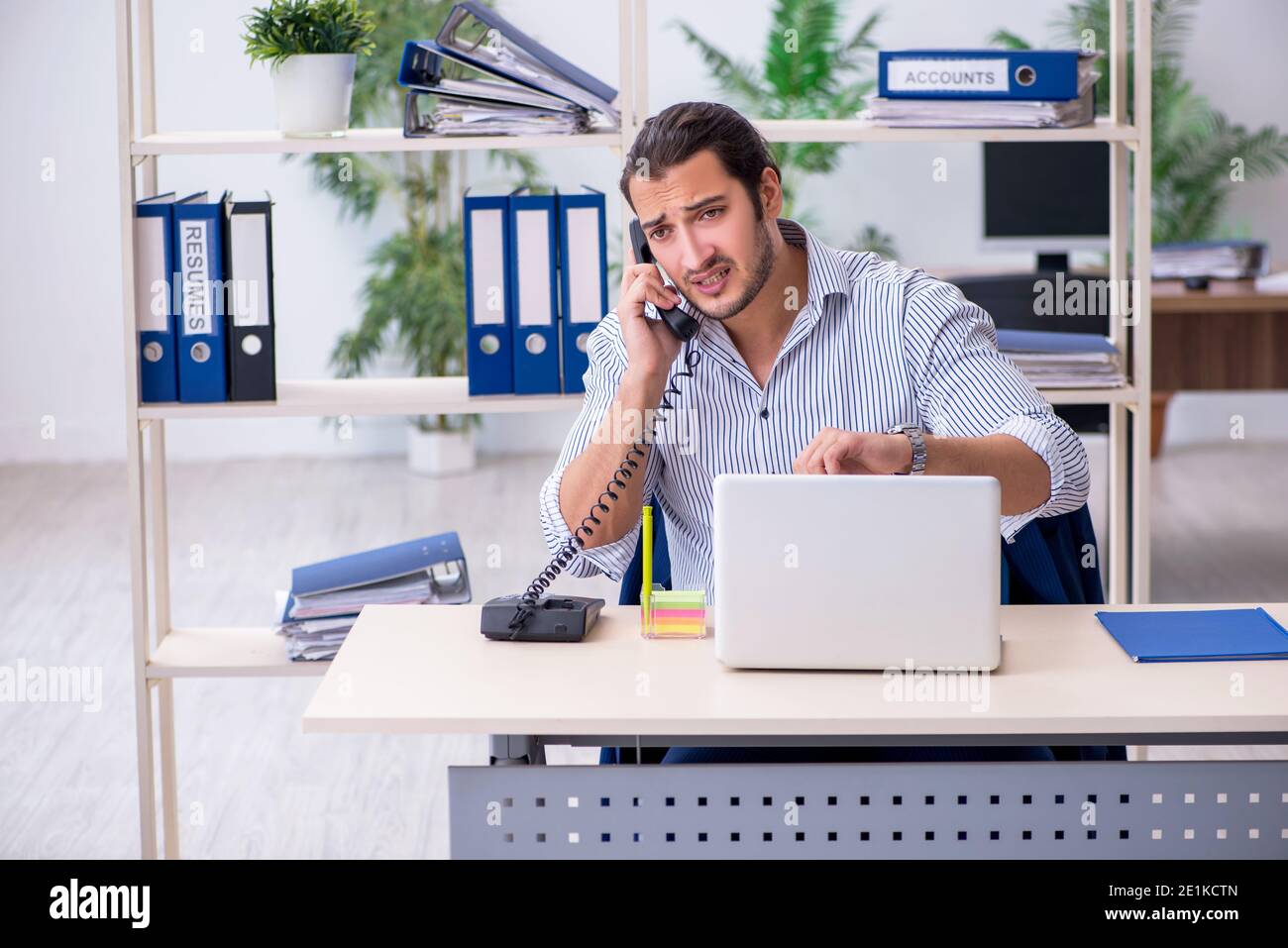 Hungry employee ordering food at workplace Stock Photo - Alamy