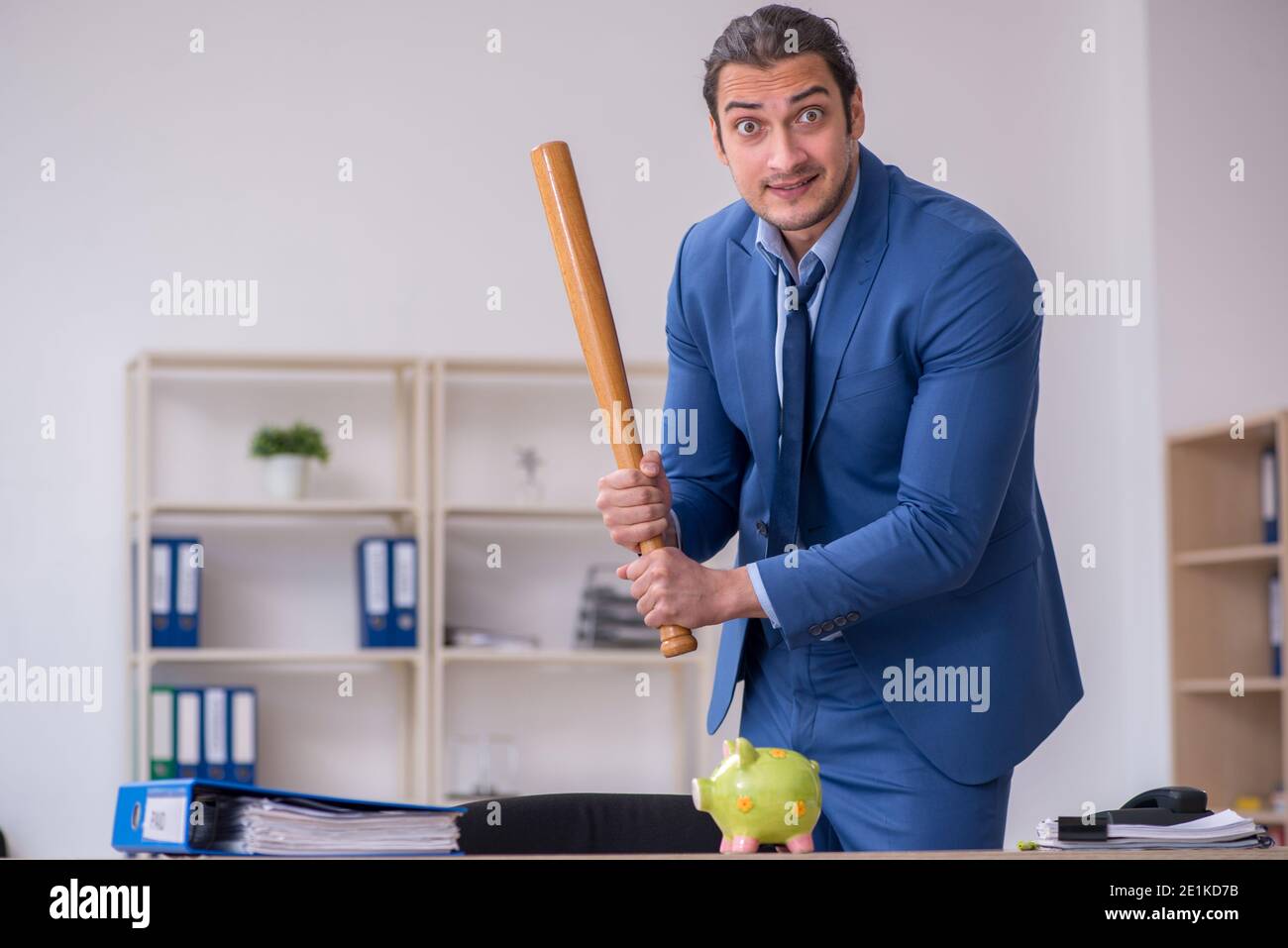 Aggressive employee with baseball bat in budget planning concept Stock ...