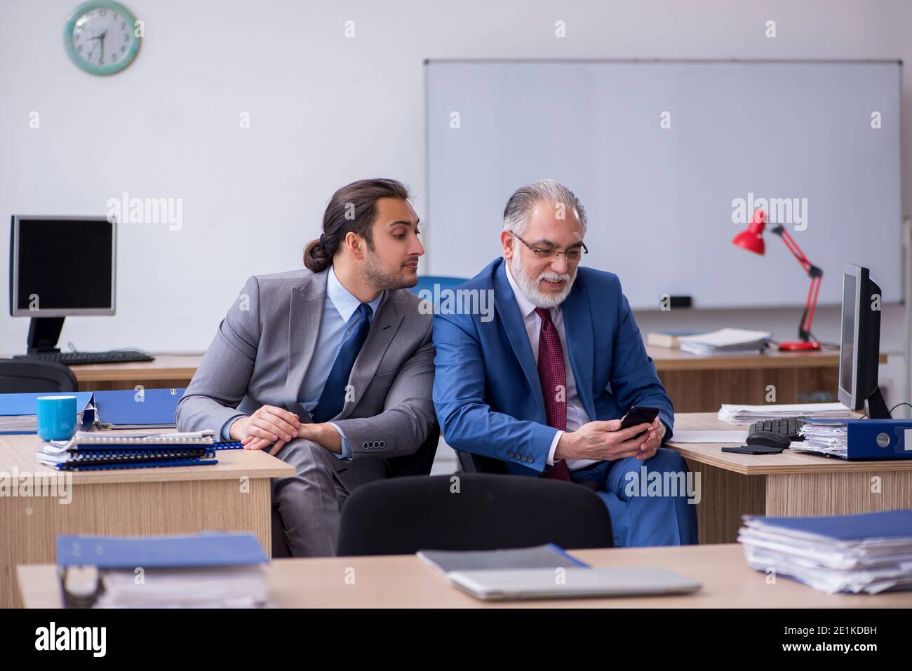 Two employees working in the office Stock Photo - Alamy