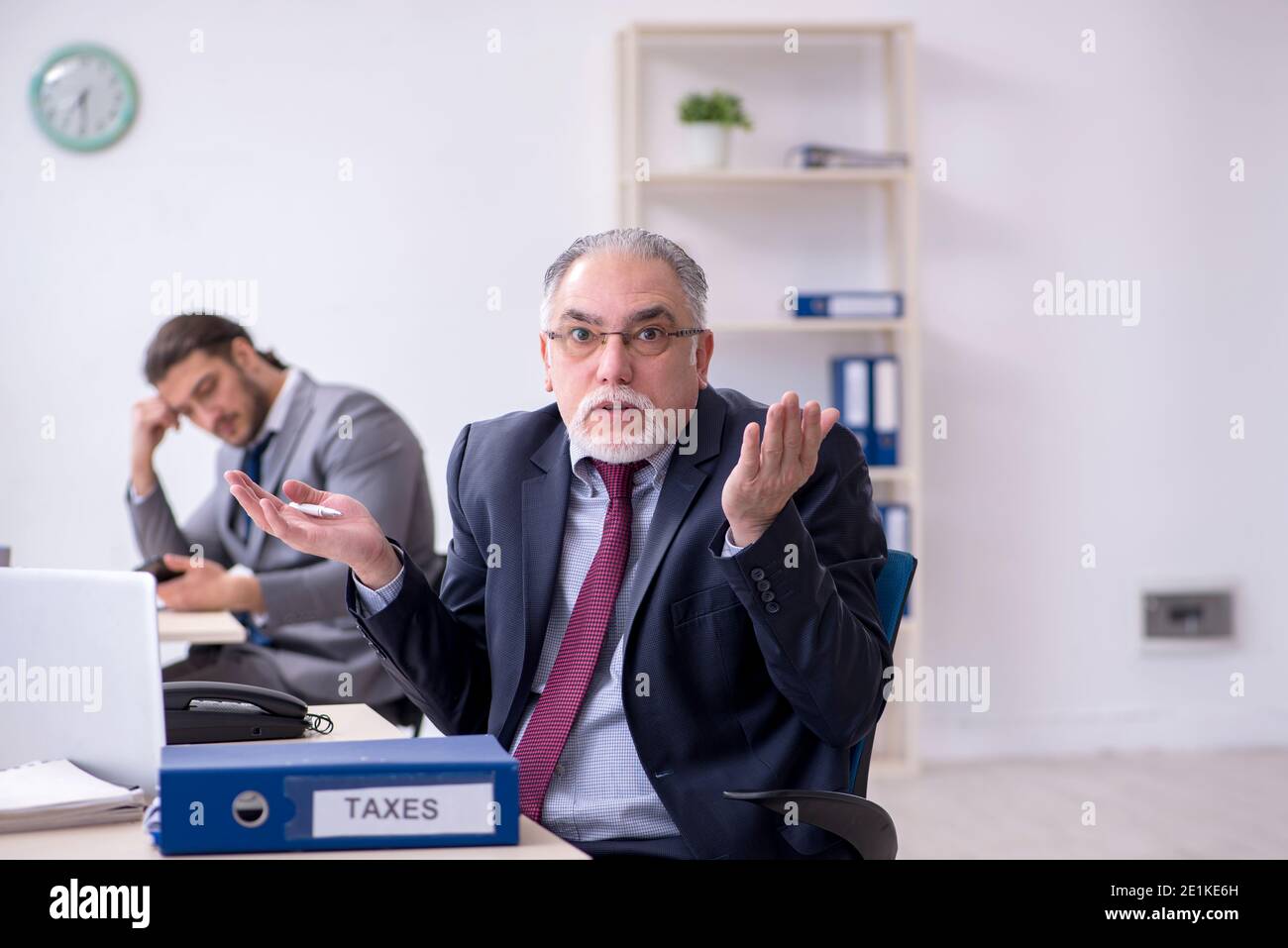 Old boss and his assistant working in the office Stock Photo - Alamy