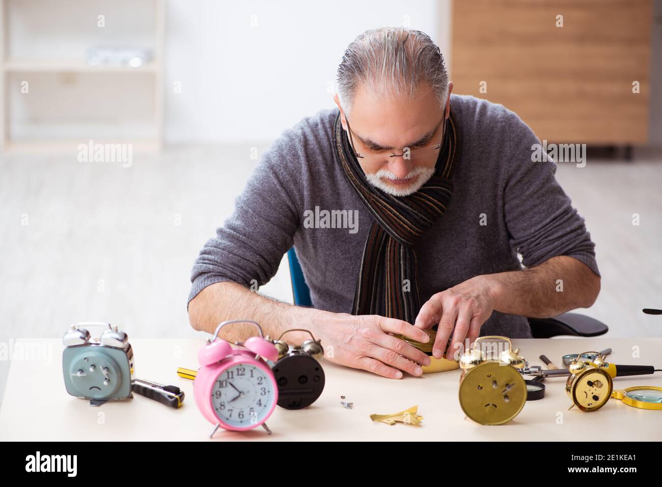 Old watchmaker working in the workshop Stock Photo - Alamy