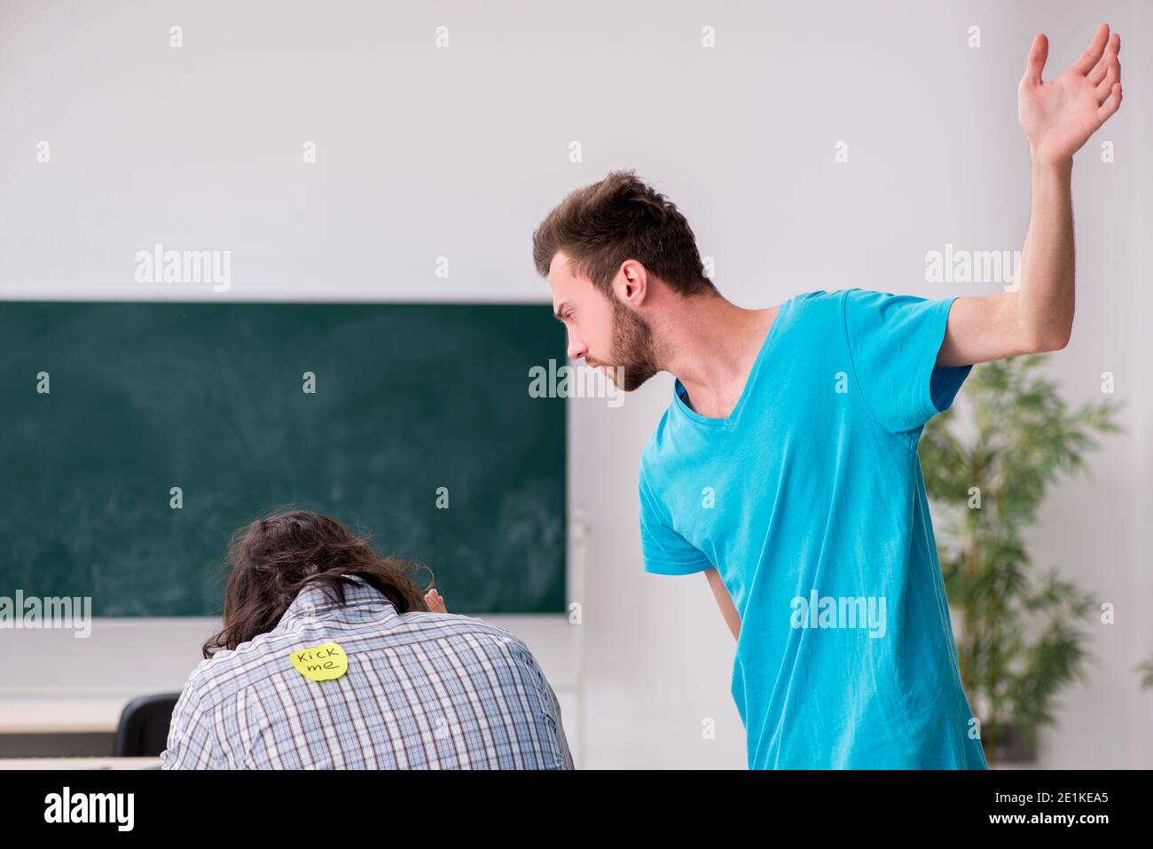 Male pupils in bullying concept in the classroom Stock Photo - Alamy