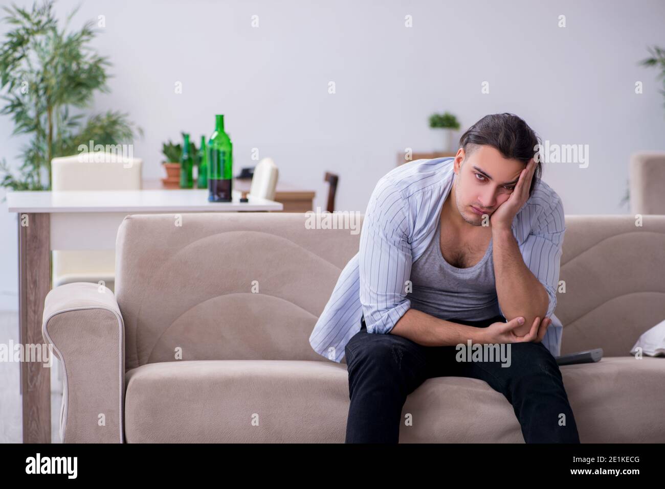 Male alcoholic drinking wine at home Stock Photo - Alamy