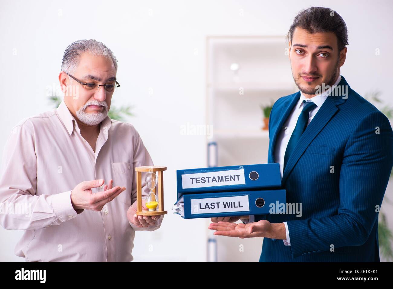 Young lawyer and old man in testament and time management concept Stock ...