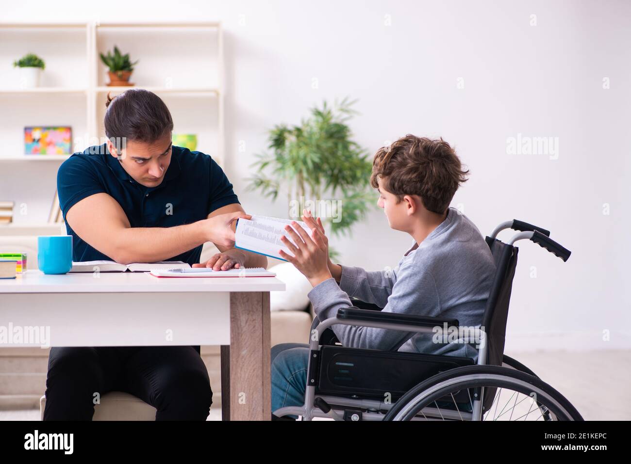 Father and disabled son in the education concept Stock Photo - Alamy