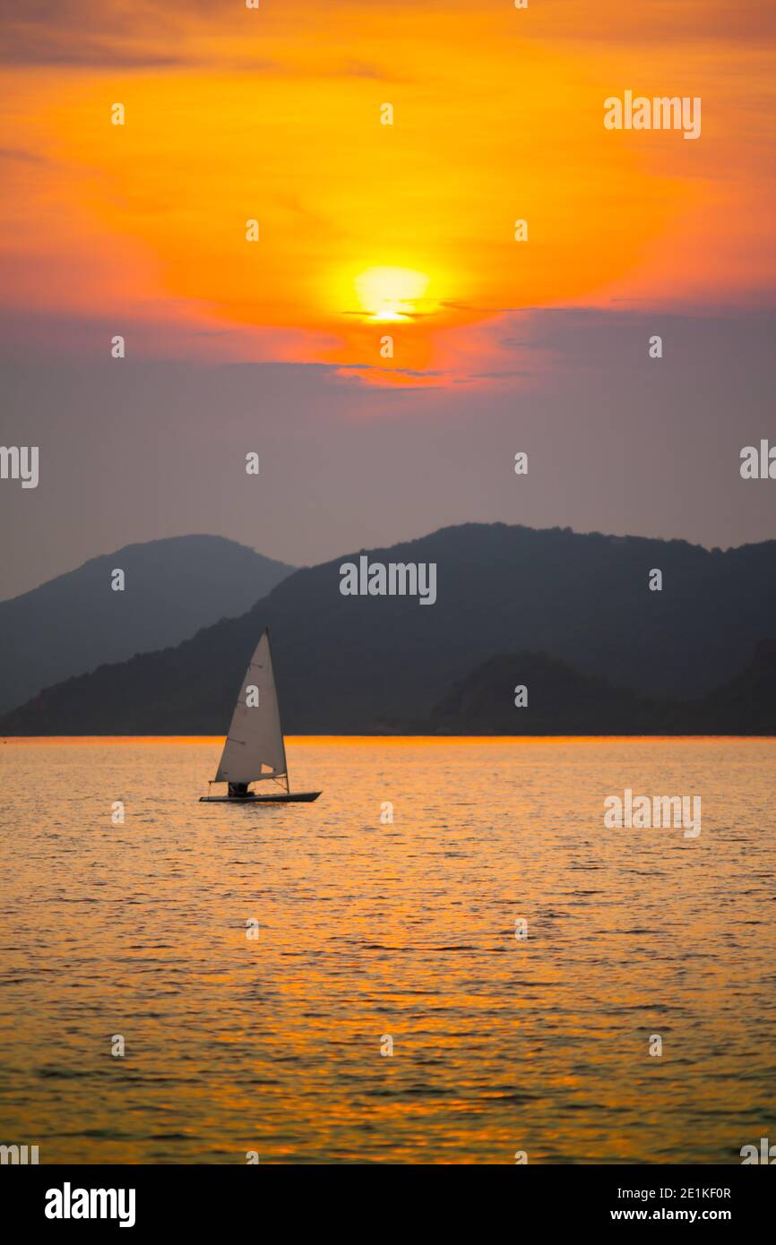 boat on the sea at sunset Stock Photo - Alamy