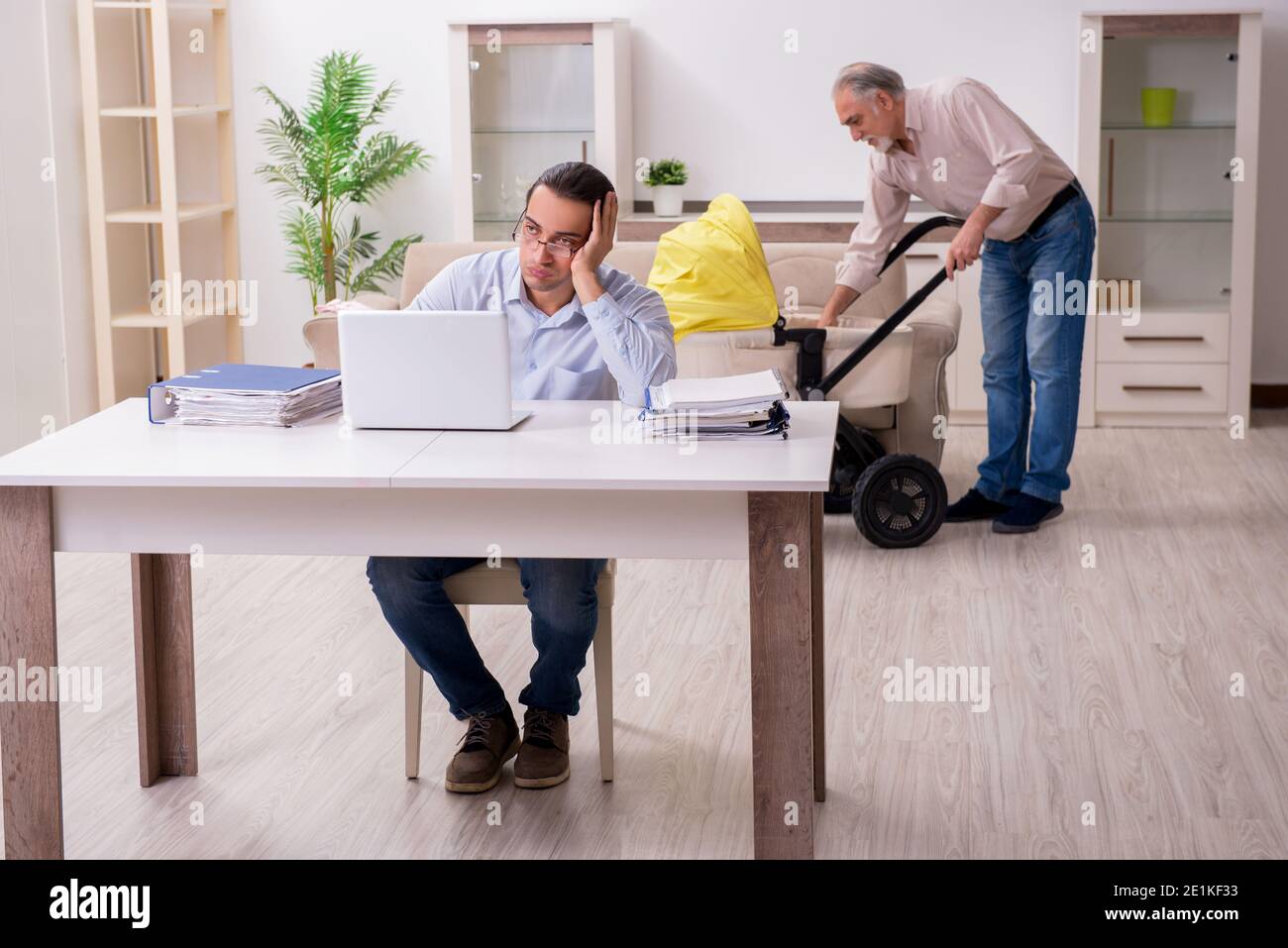 Old grandfather looking after newborn at home Stock Photo - Alamy