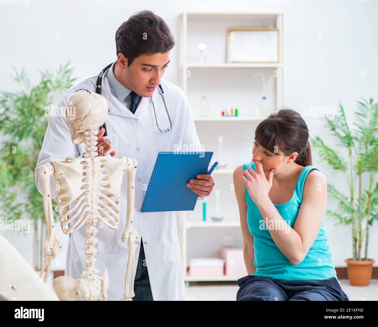 The doctor showing type of injury on skeleton to patient Stock Photo ...