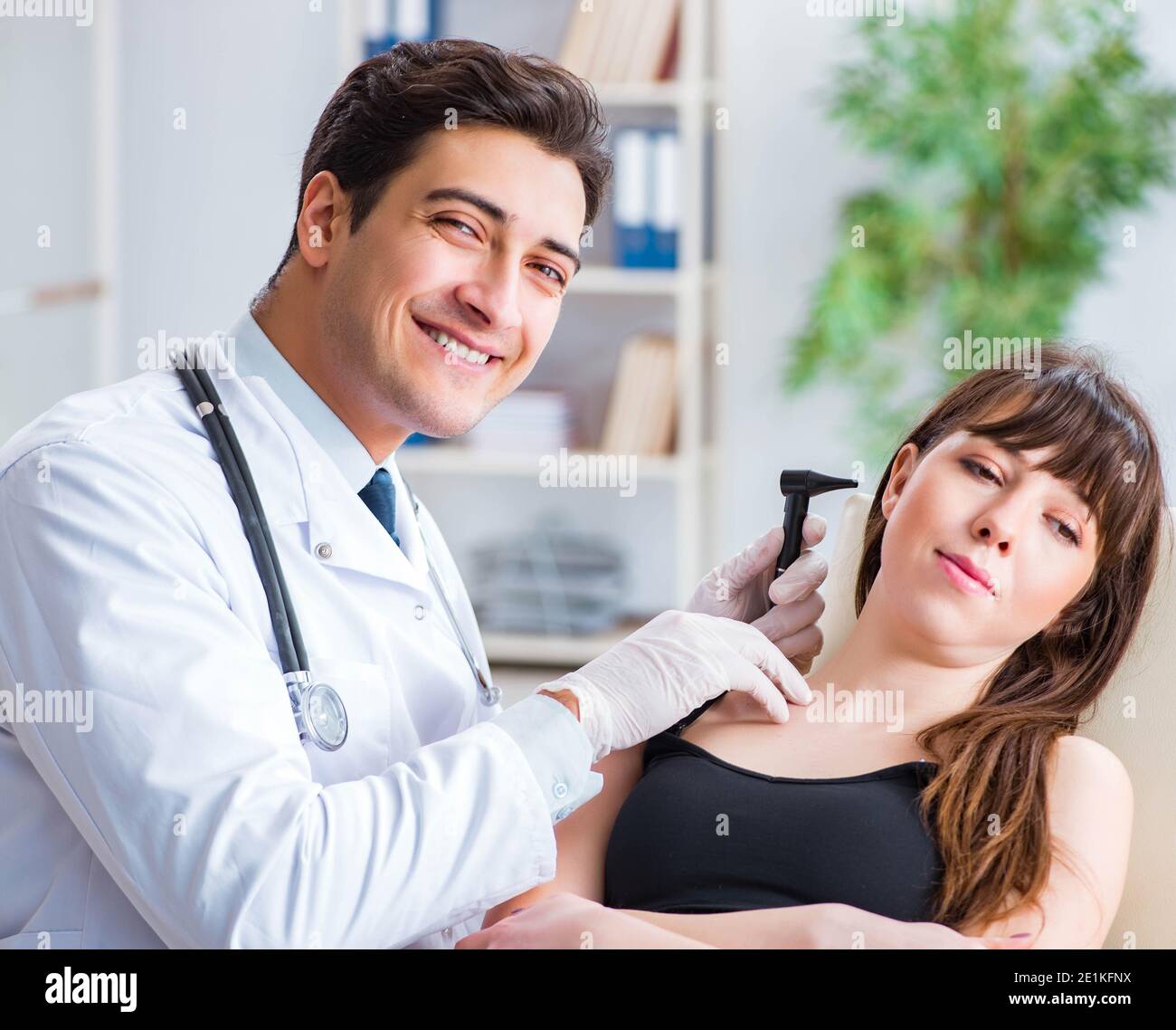The doctor checking patients ear during medical examination Stock Photo ...