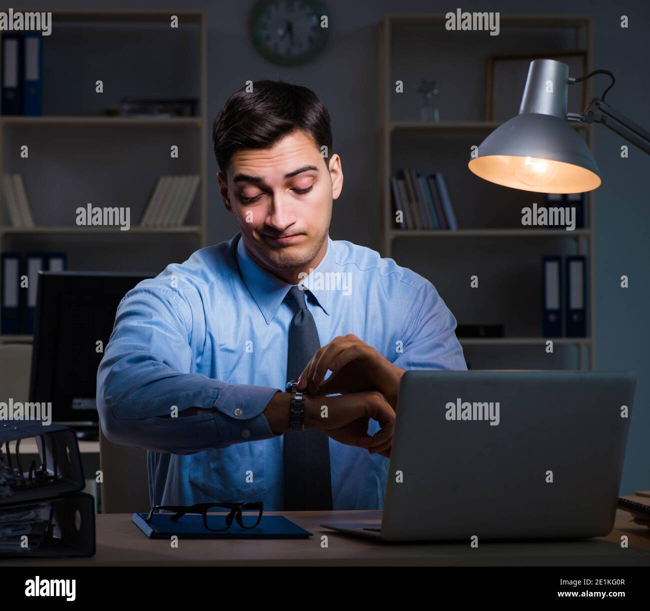 The employee working late at night at important report Stock Photo - Alamy
