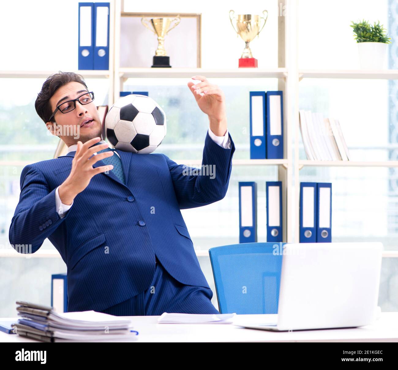 The businessman playing football in the office Stock Photo - Alamy