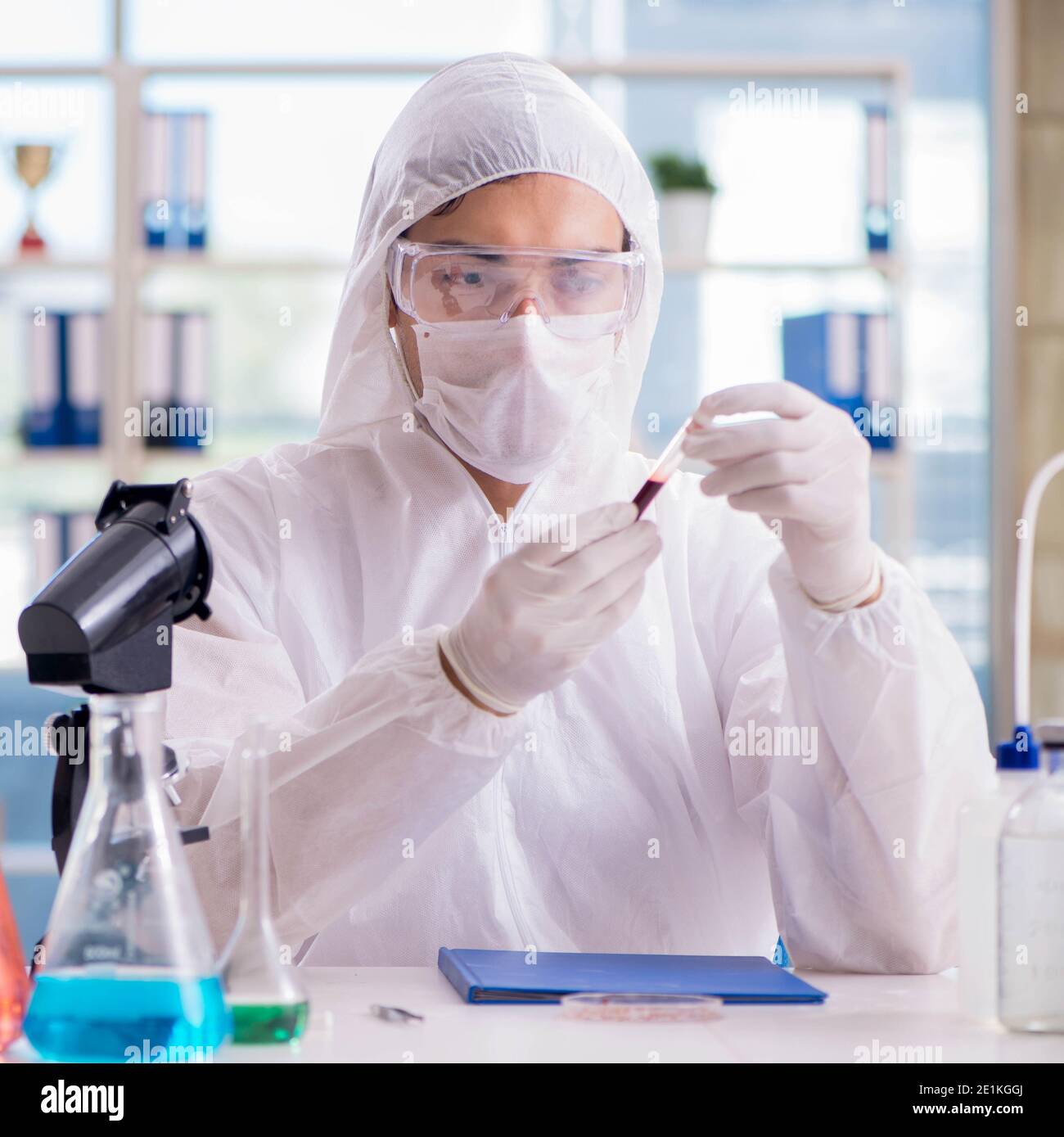 The chemist working in the laboratory with hazardous chemicals Stock ...