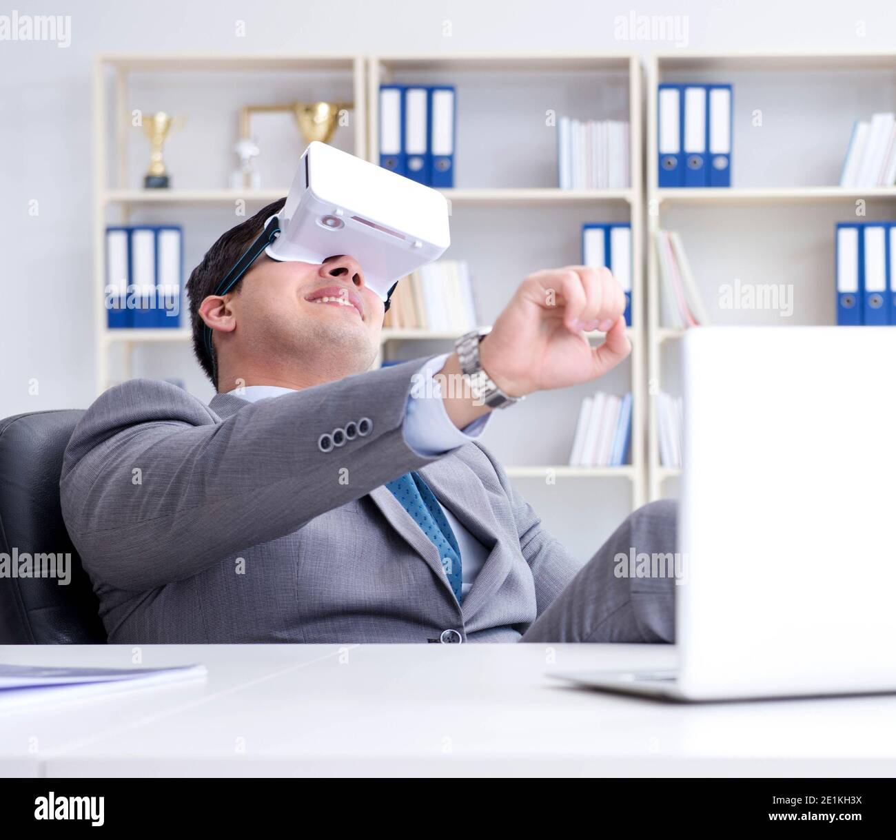 Businessman with virtual reality glasses in modern technology concept ...
