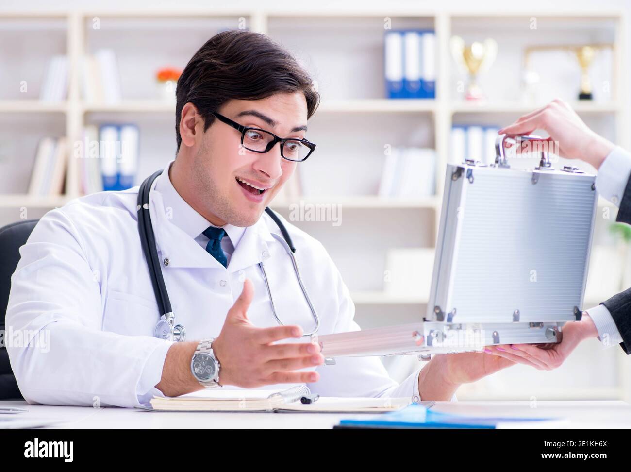 The young doctor in medical insurance fraud concept Stock Photo - Alamy