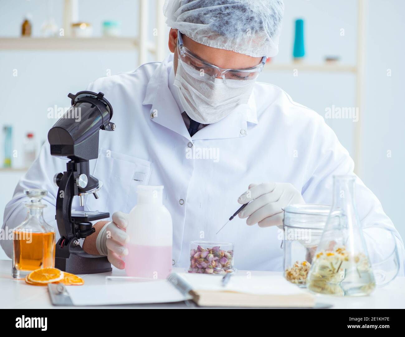 The chemist mixing perfumes in the lab Stock Photo - Alamy