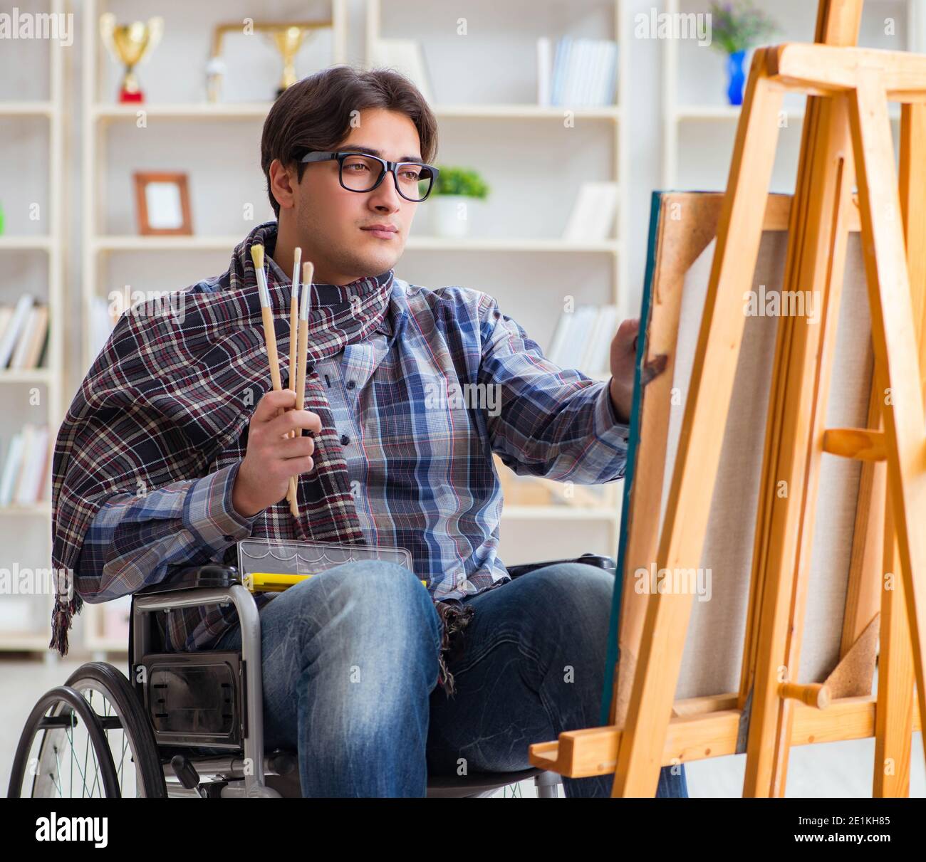 The disabled artist painting picture in studio Stock Photo - Alamy