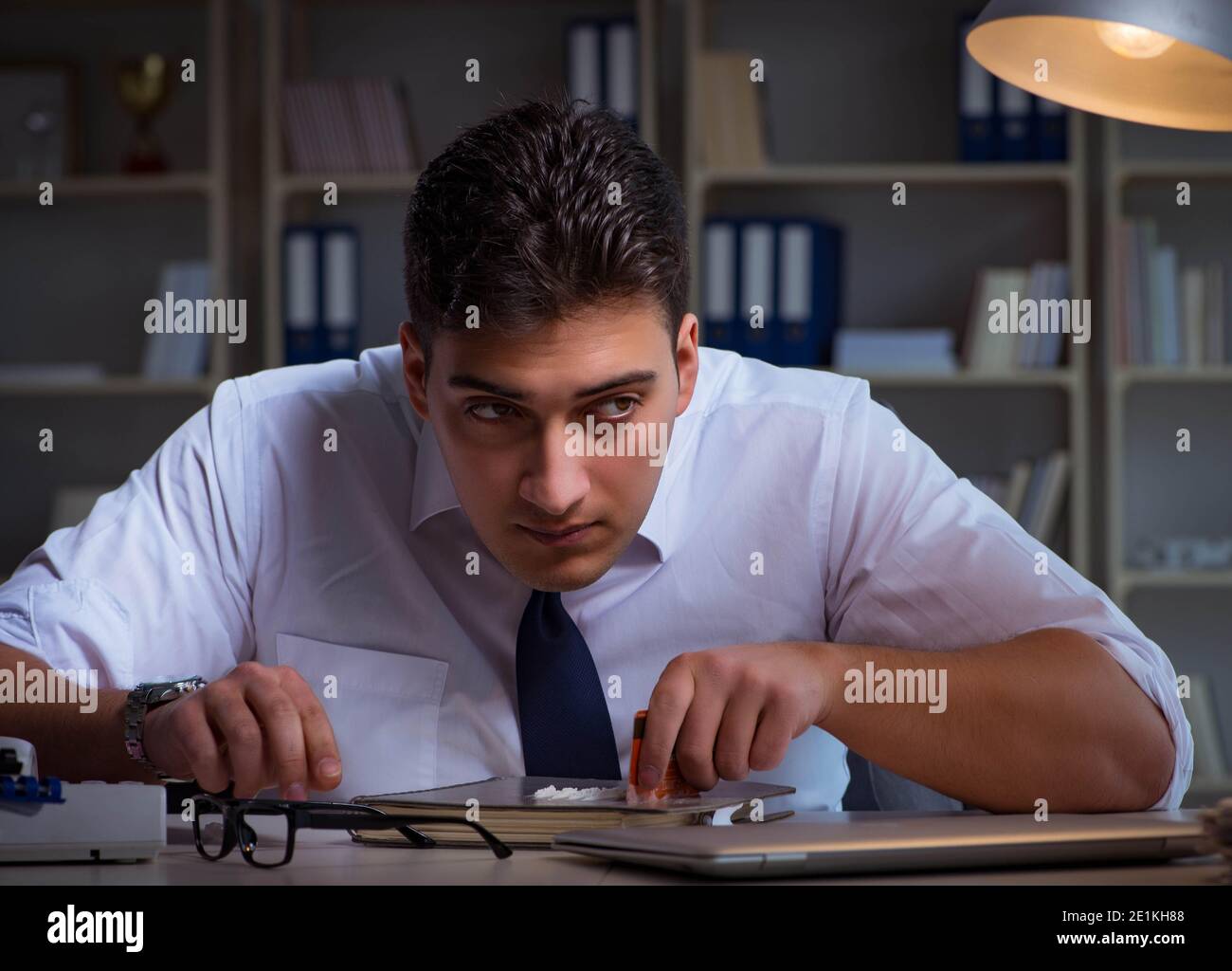 The businessman staying late in office for drugs Stock Photo - Alamy