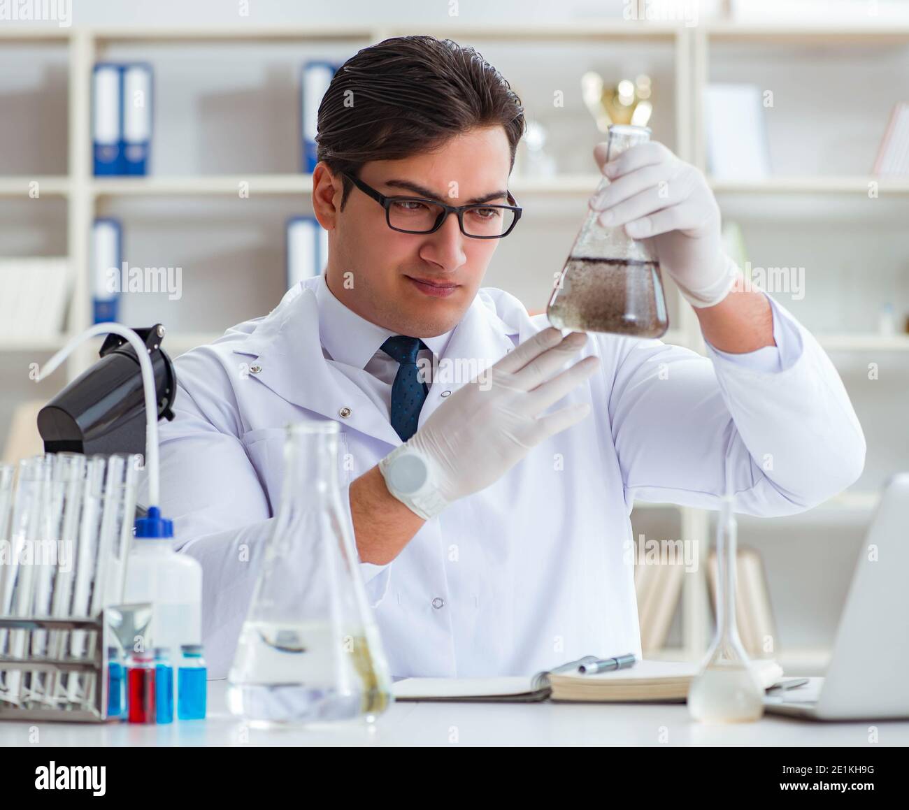 Young researcher scientist doing a water test contamination experiment ...
