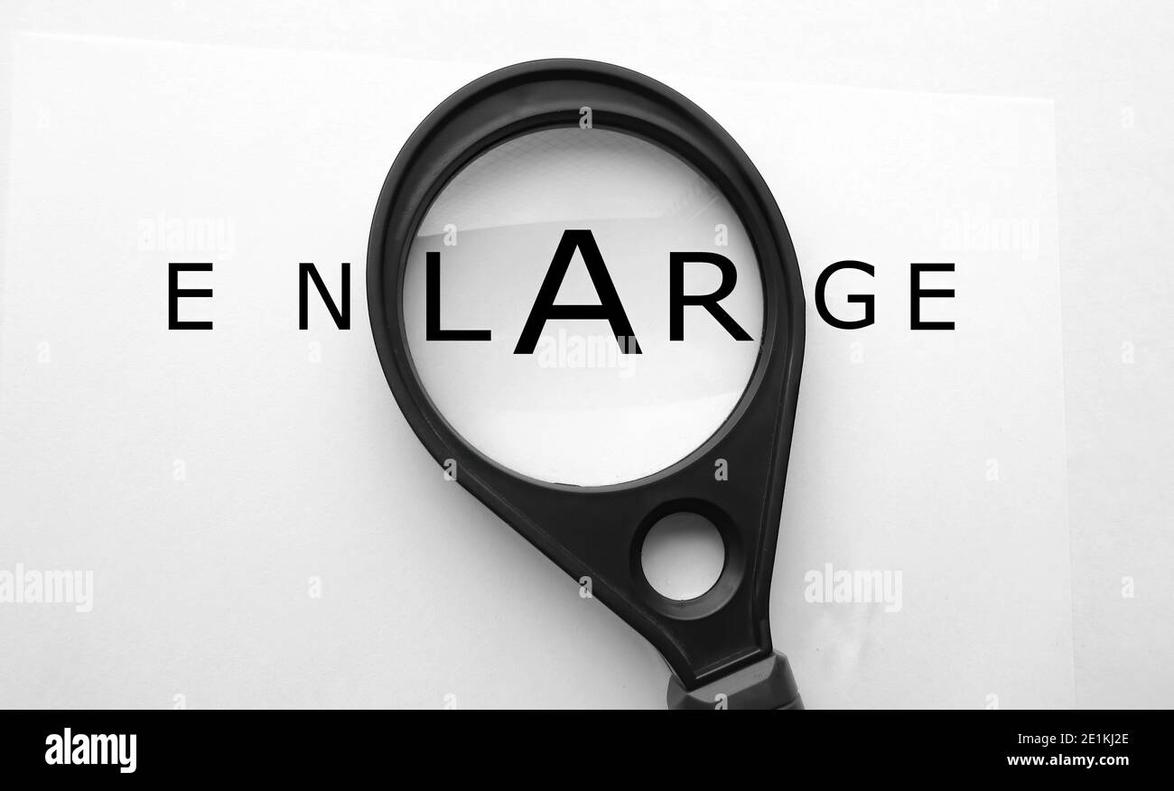 Enlarge text with a magnigying Glass Stock Photo - Alamy