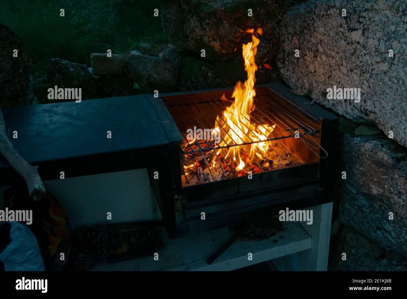 Barbecue fireplace with burning flame Stock Photo - Alamy