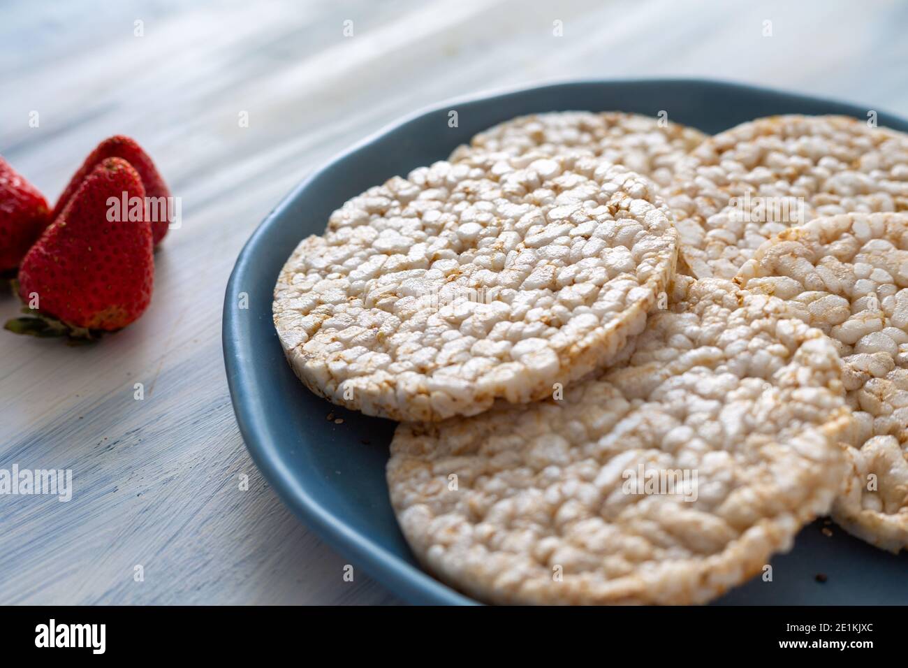 rice crackers, whit fruits on table blue, super food Stock Photo - Alamy
