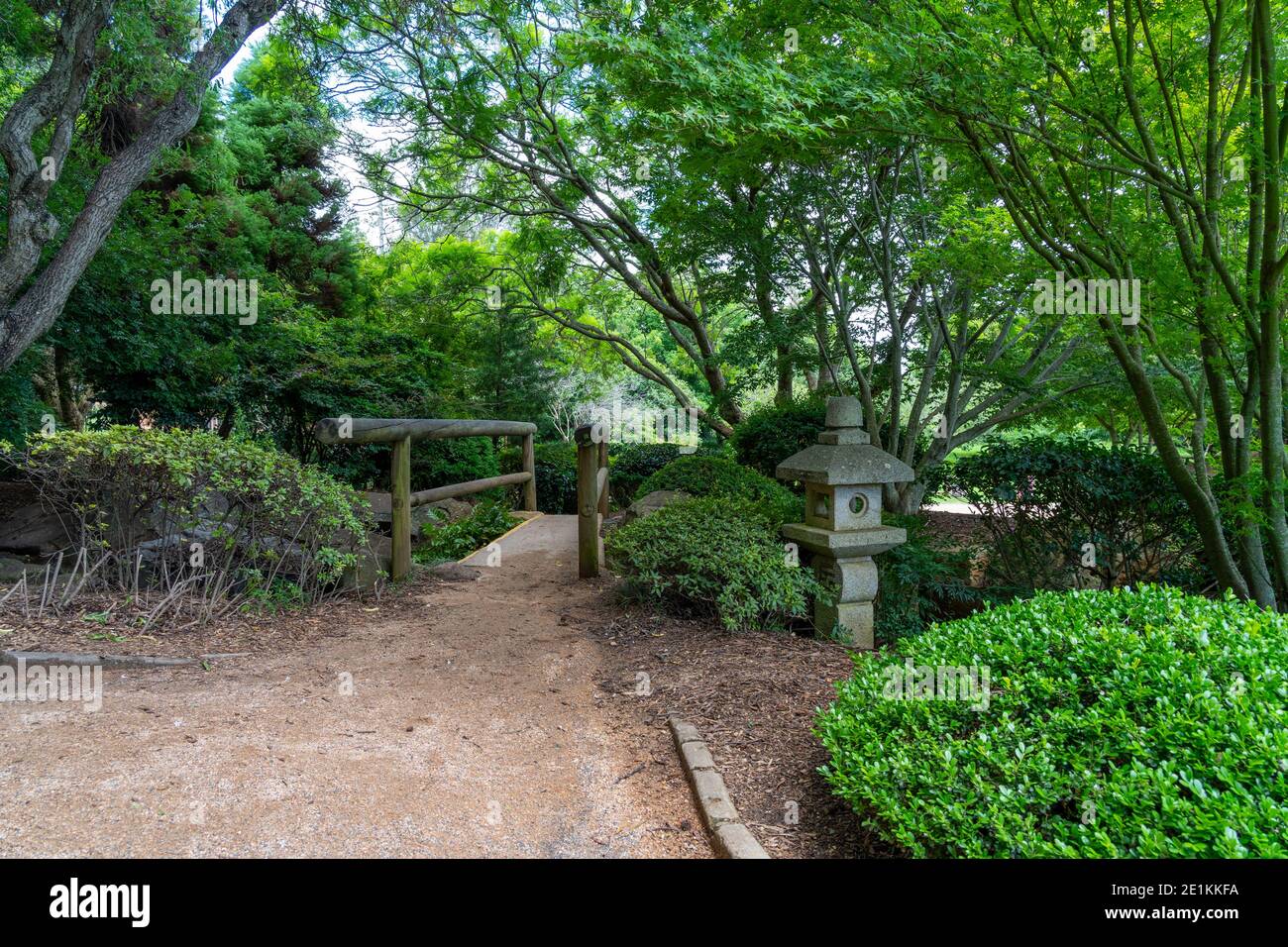foot bridge with wooden handrail next to a shrine at the Japanese ...