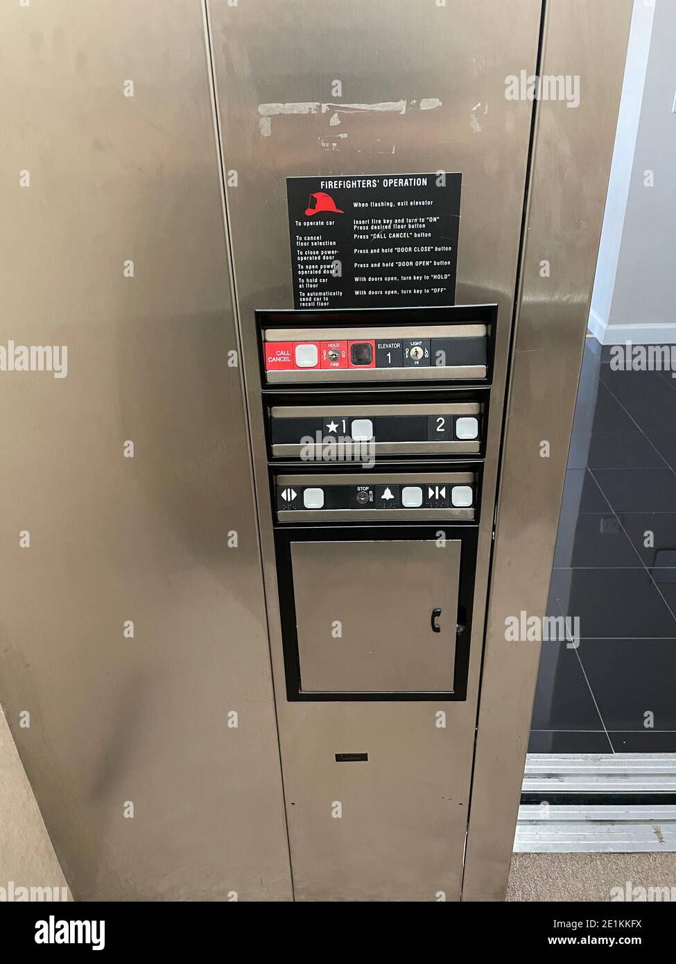 Elevator user control panel one and two floors looking down distant ...