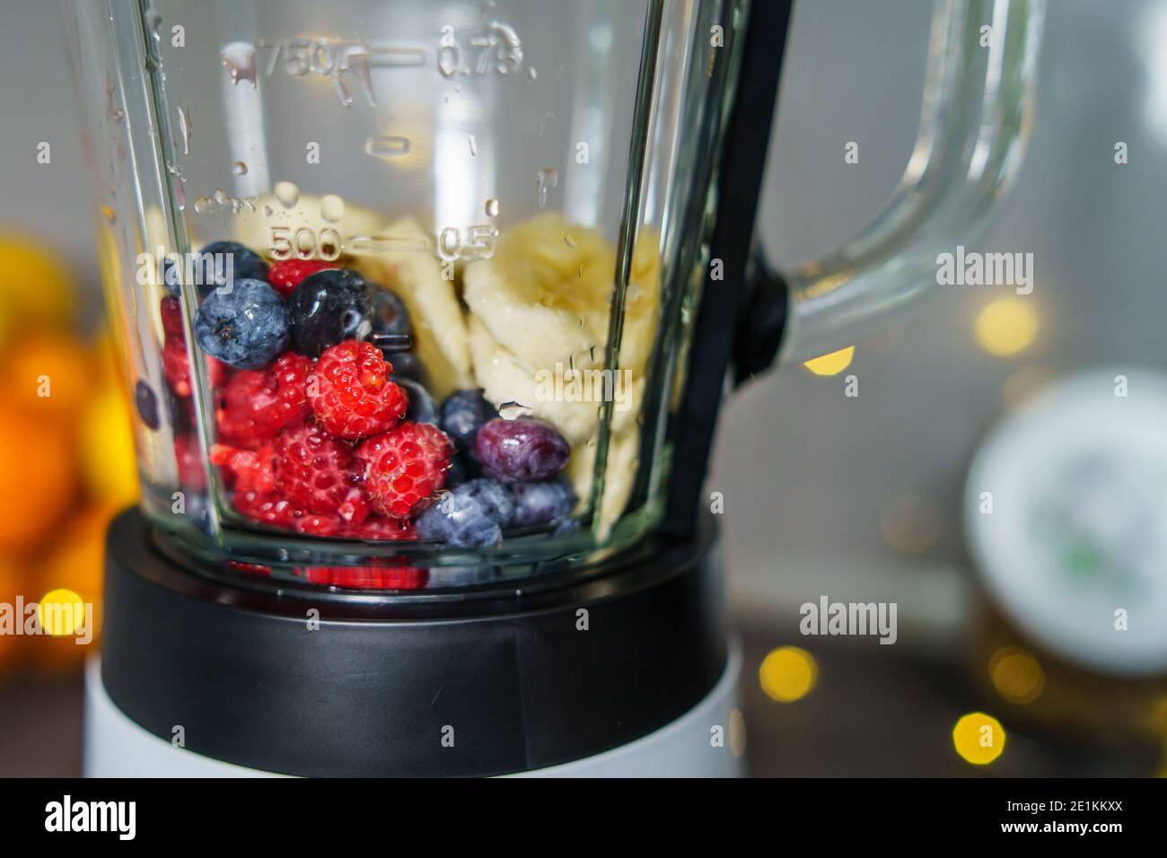 front view on fruits in blender - fresh organic blueberries raspberries ...