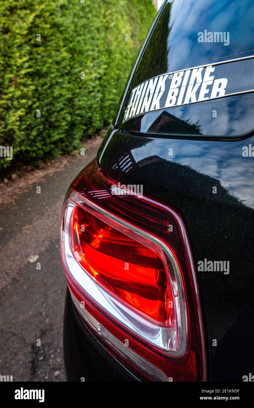 Think bike think rider sticker on car rear Stock Photo - Alamy