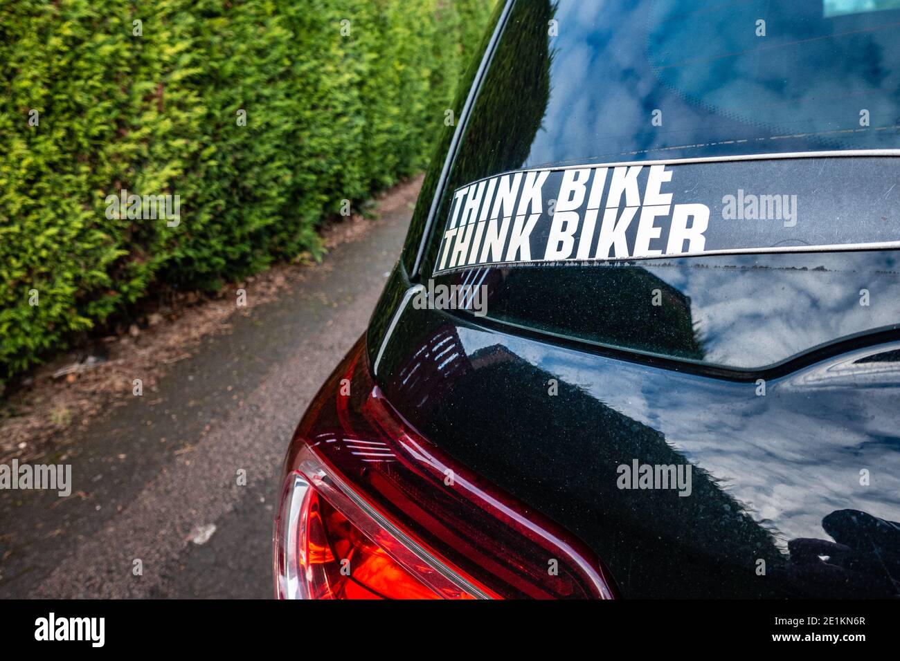 Think bike think rider sticker on car rear Stock Photo - Alamy