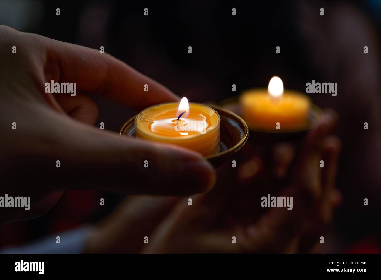 People holding small candle holders in the blessing Stock Photo - Alamy