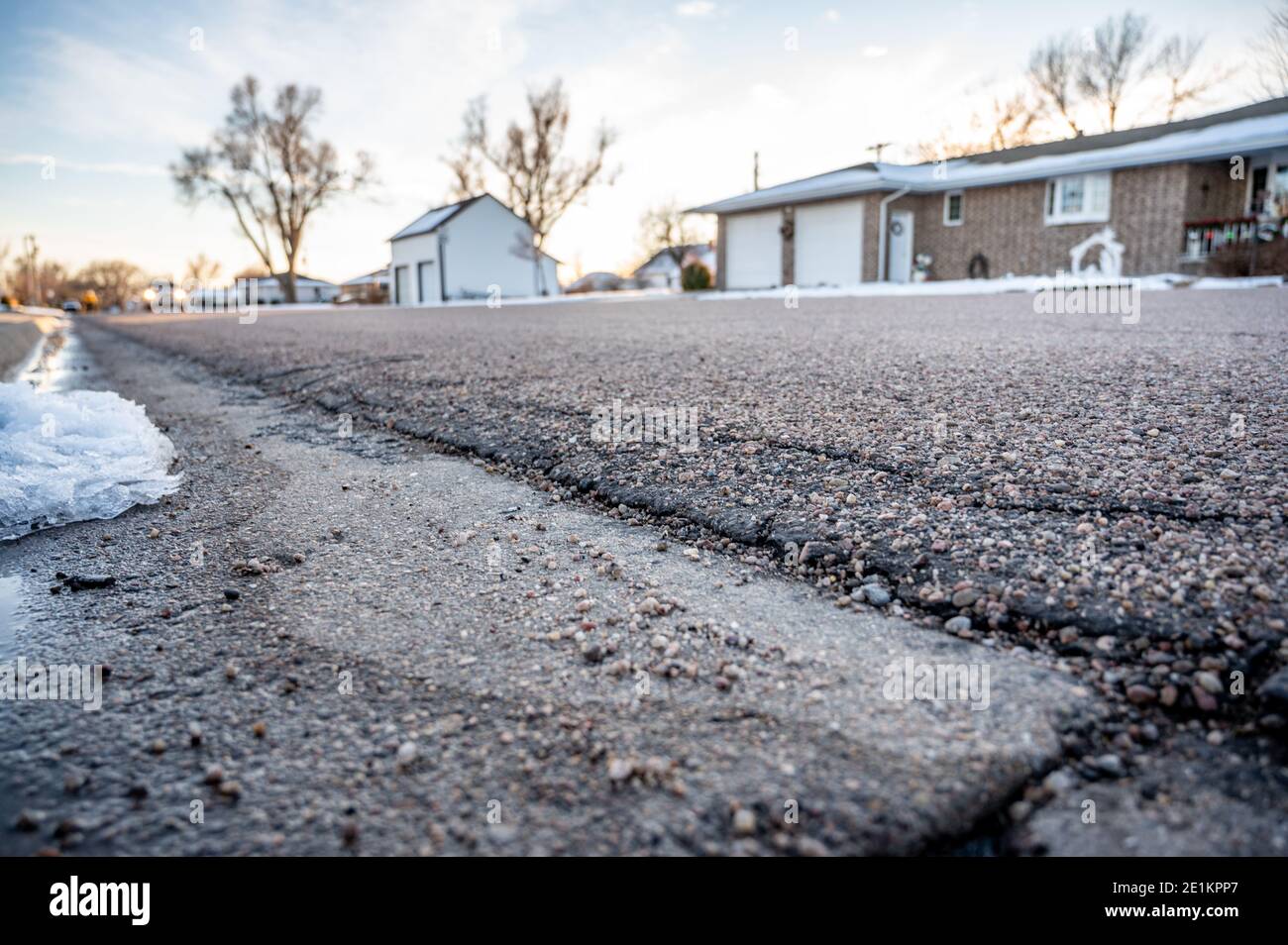 Method of applying an asphalt layer on top of an existing concrete ...