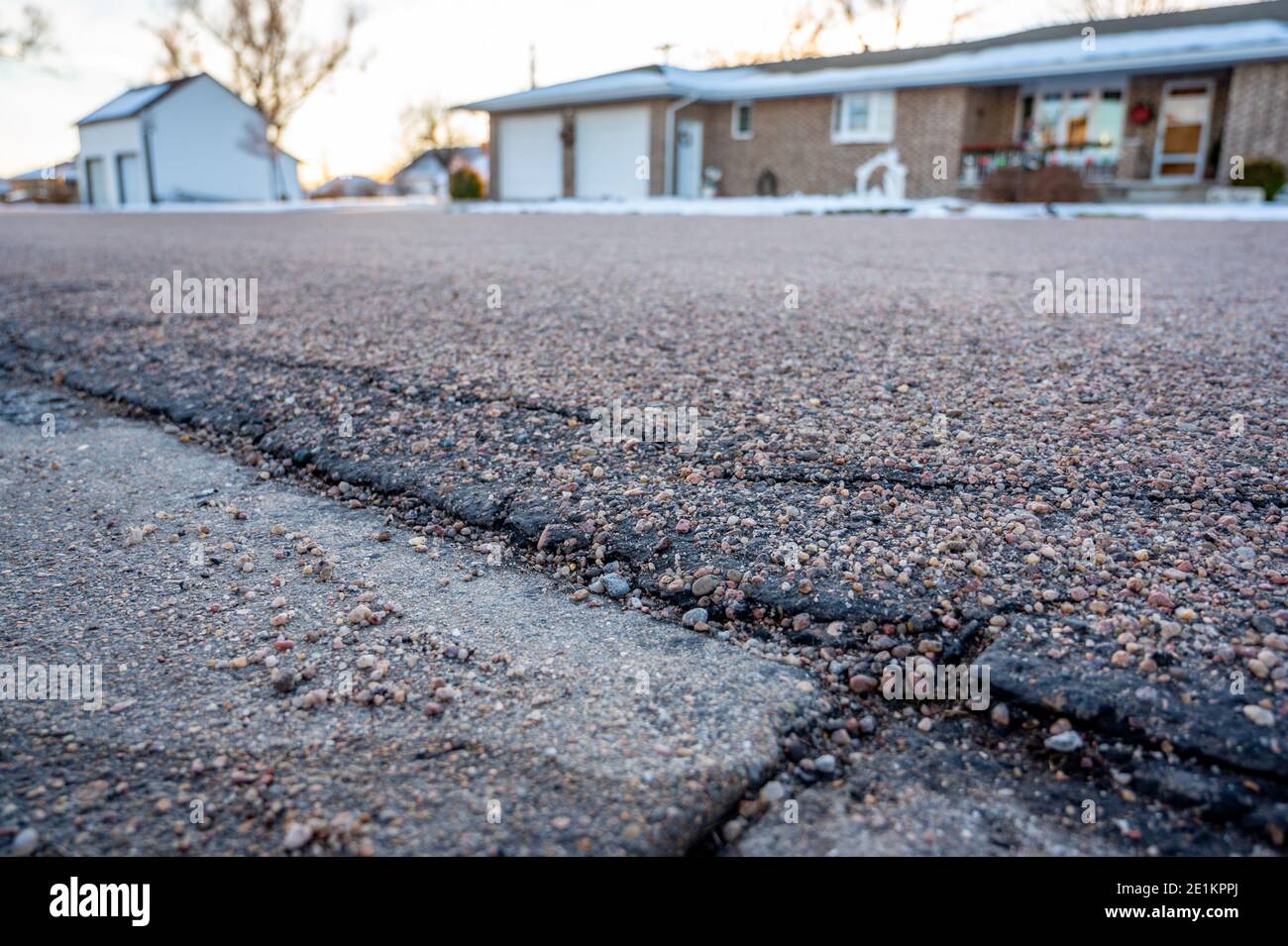 Method of applying an asphalt layer on top of an existing concrete ...