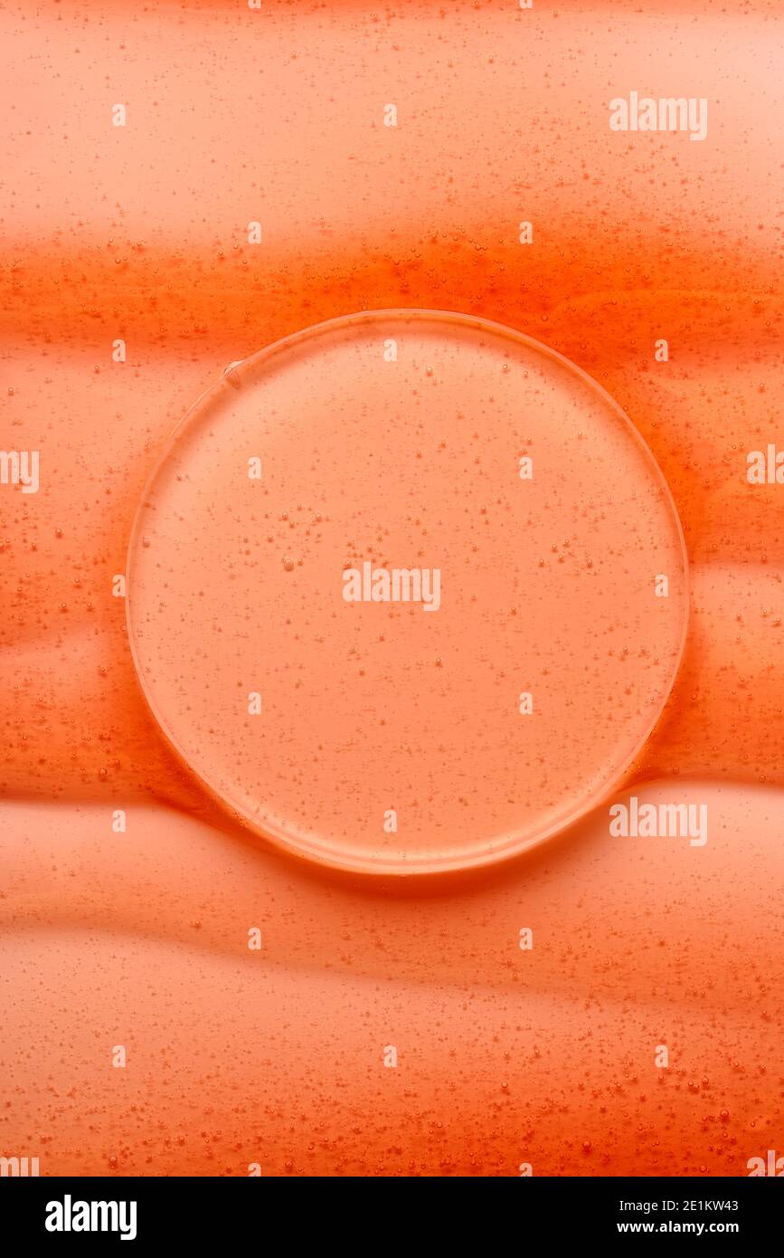 The texture of the red transparent cosmetic gel. Abstract background ...