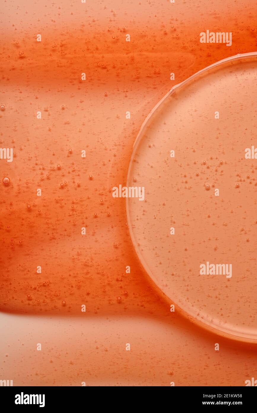 The texture of the red transparent cosmetic gel. Abstract background ...