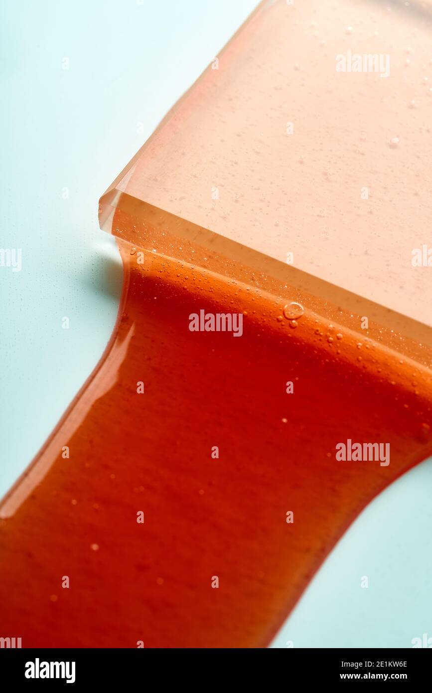 The texture of the red transparent cosmetic gel. Abstract background ...