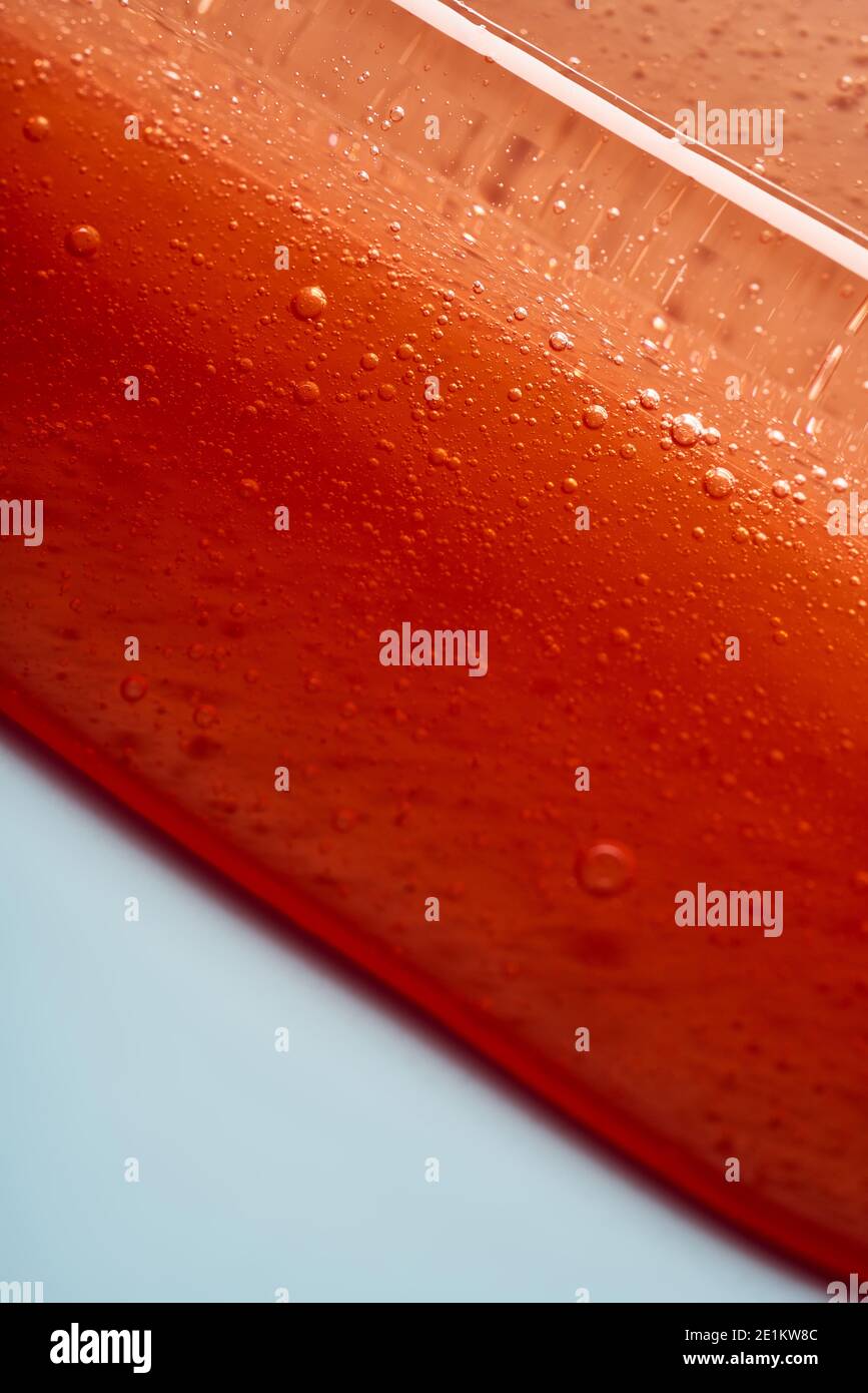 The texture of the red transparent cosmetic gel. Abstract background ...