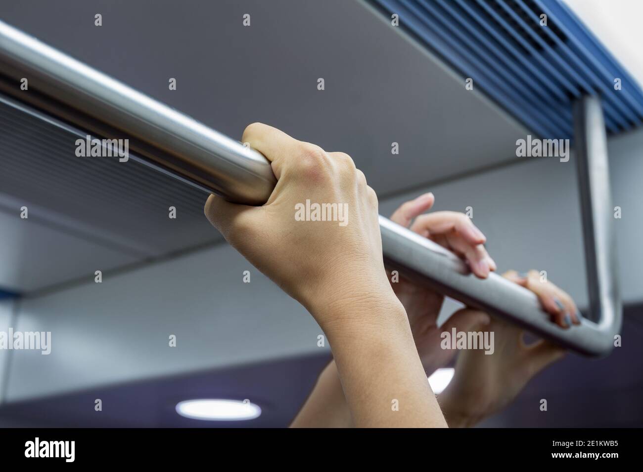 People holding handrail tightly on work or after work Stock Photo - Alamy