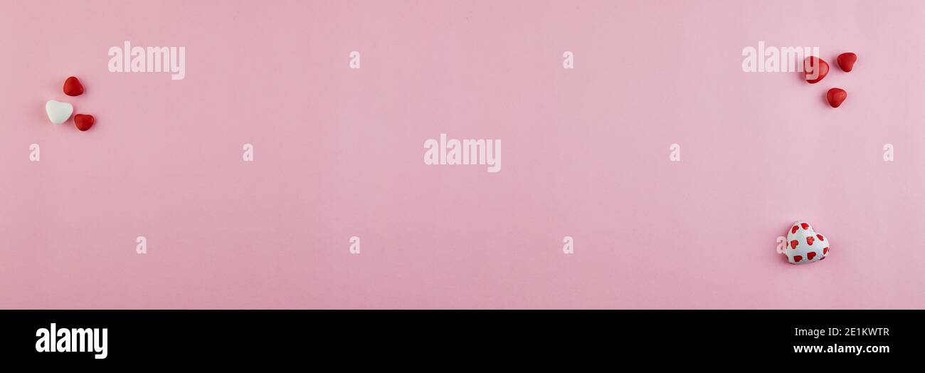 Valentine's day banner with candy hearts on pink background. Top view ...