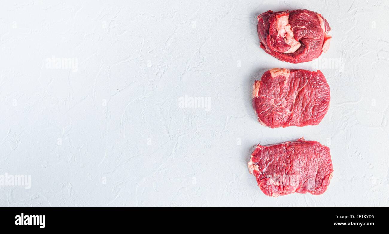 A set of different types of raw beef steaks:top blade, rump, chuck eye ...