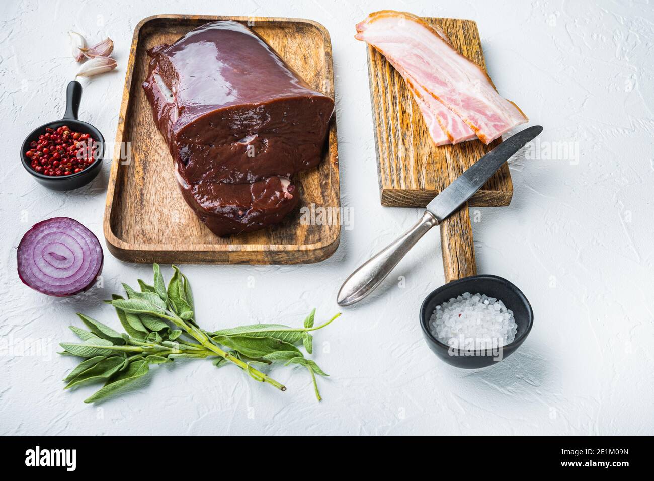 Raw liver with smoked bacon on white background Stock Photo - Alamy