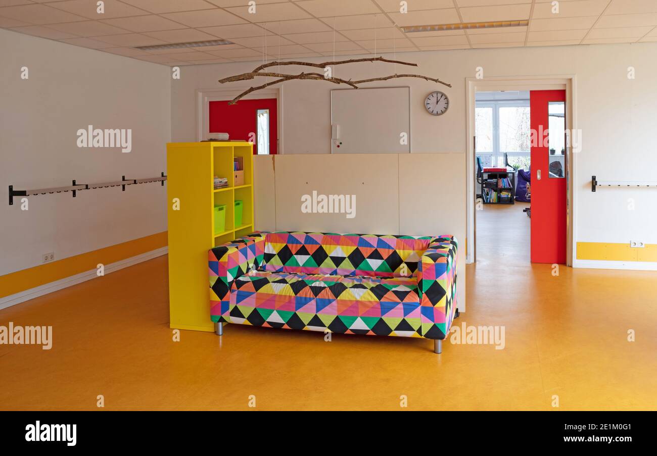 Waiting area in a school, colorful couch Stock Photo - Alamy