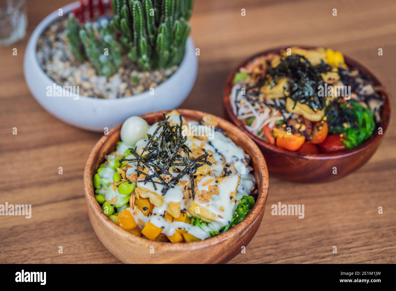 Raw Organic Poke Bowl with Rice and Veggies close-up on the table. Top ...