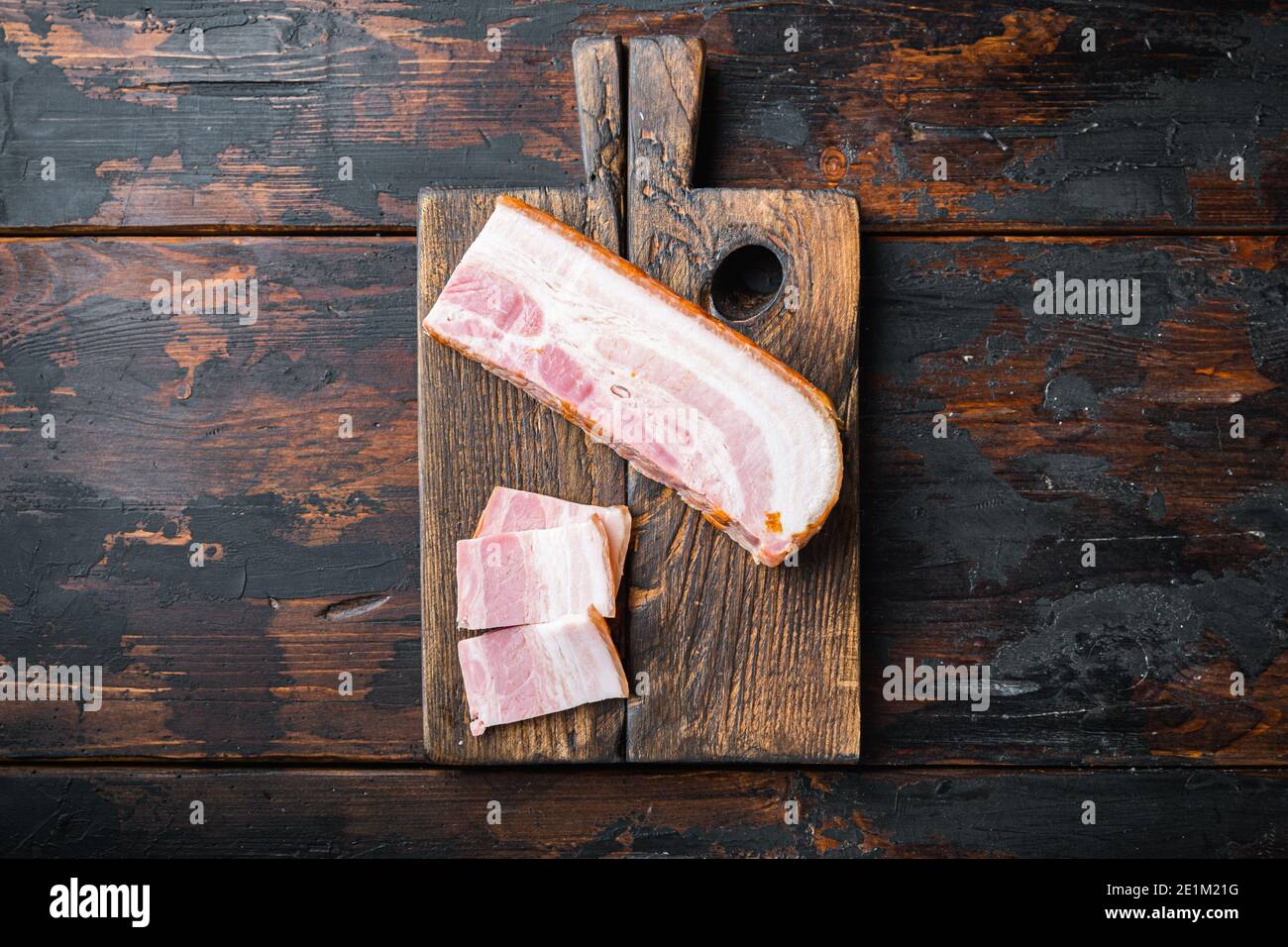 Bacon pancetta cut and sliced on wooden surface, top view with space ...